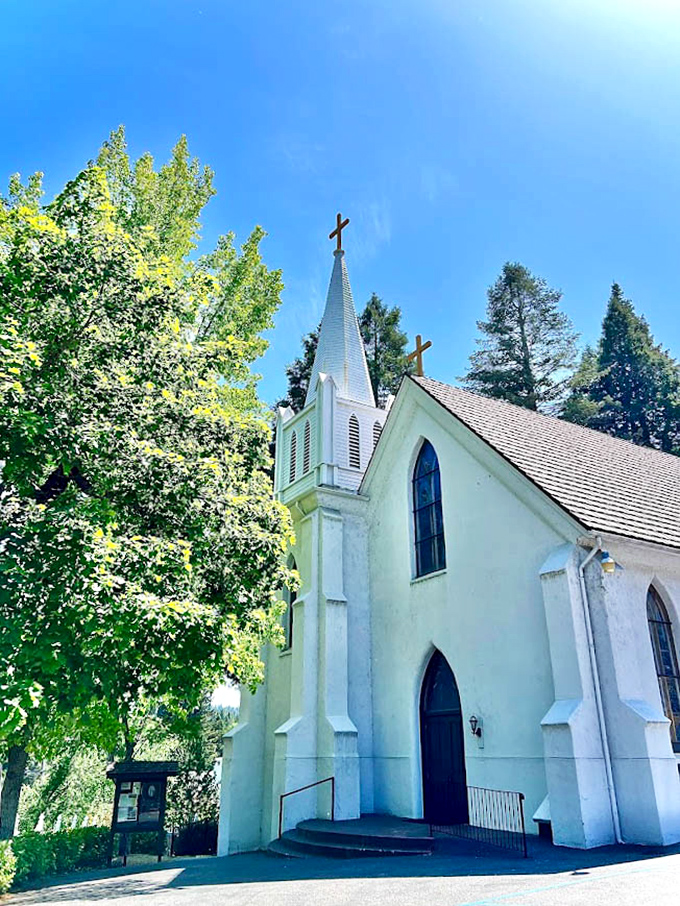 St. Canice Catholic Church's pristine white facade glows against the Sierra blue sky. Spiritual solace with a side of architectural beauty.