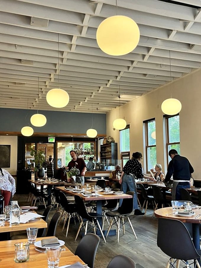 The dining room buzzes with the energy of happy eaters. Those globe lights aren't just illuminating the space—they're spotlighting culinary magic.