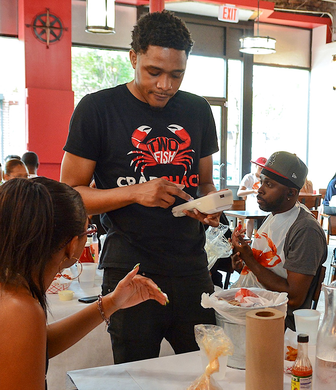 The staff orchestrates the seafood experience with practiced precision. These are the unsung heroes behind your food coma.