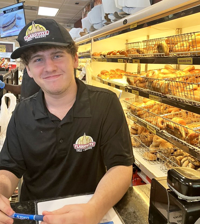 Behind every great deli is a team that knows their bagels&mdash;this staff member's smile suggests he's in on all the delicious secrets.