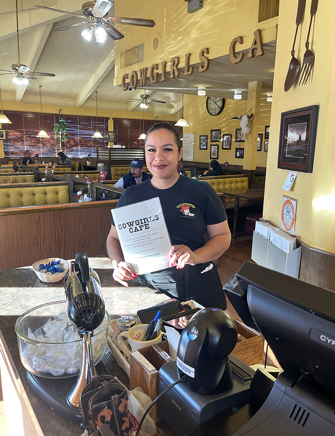 The friendly staff at Cowgirls Cafe treats the menu like a sacred text. That smile says, "Trust me, you're going to love this."