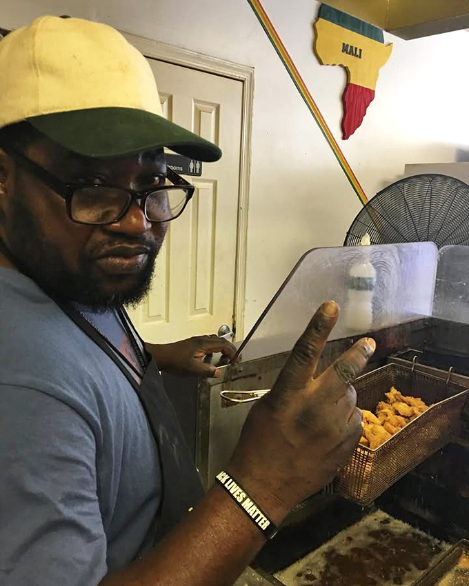 The maestro at work, giving those shrimp the golden treatment they deserve. His thumbs-up isn't just a gesture—it's a quality guarantee backed by countless satisfied customers.