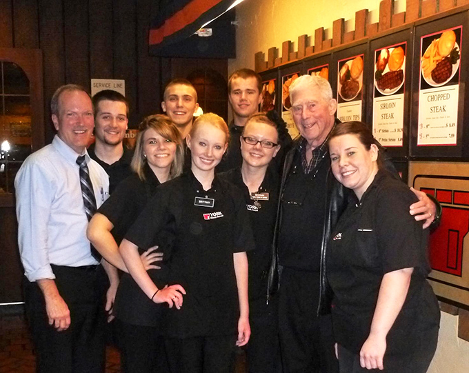 The dedicated team behind York's enduring success shares a moment together, representing the human element that keeps this steakhouse feeling like home rather than just another restaurant.