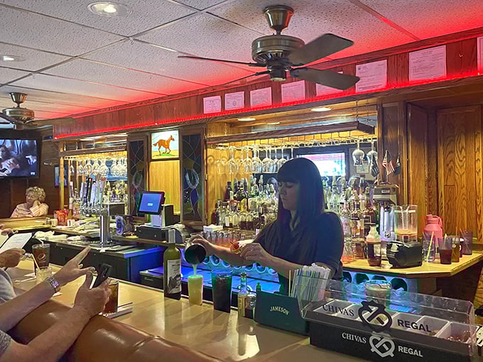 Behind every great bar is someone who knows exactly what you're going to order before you do. The red lighting isn't ambiance&mdash;it's tradition. 