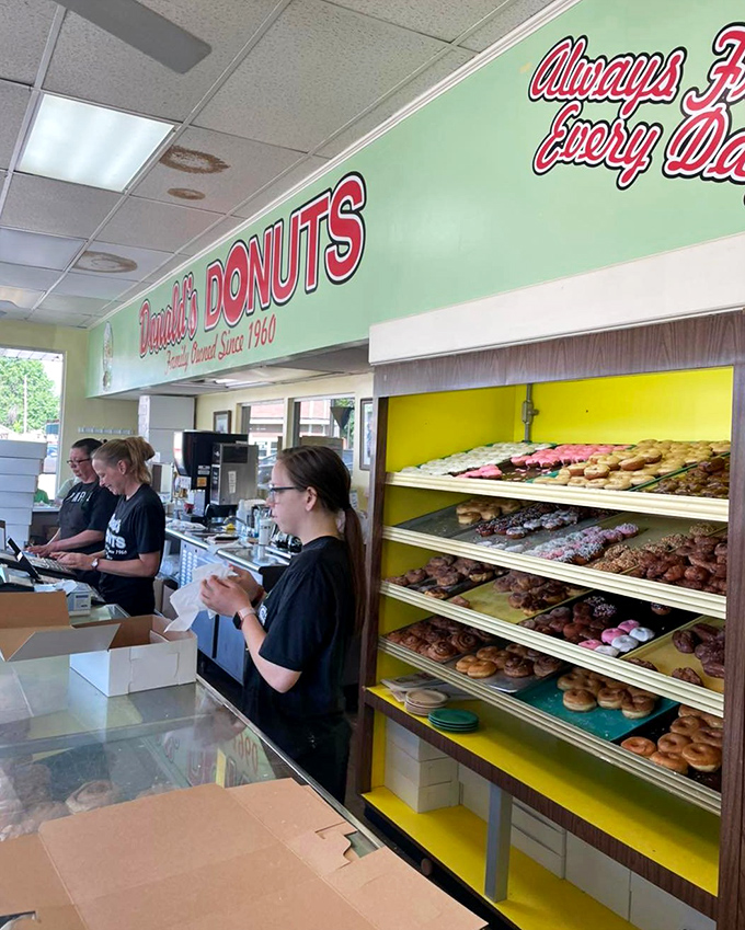 The staff moves with the choreographed precision of people who know they're not just making donuts&mdash;they're making someone's day better.