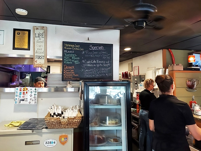 Food appears through this window like culinary magic, delivered by kitchen wizards who transform simple ingredients into memorable meals.