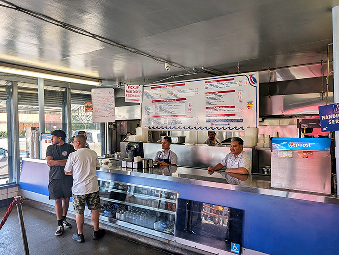 The kitchen crew works their magic behind the counter, turning simple ingredients into seafood gold. These are the unsung heroes of your lunch satisfaction.