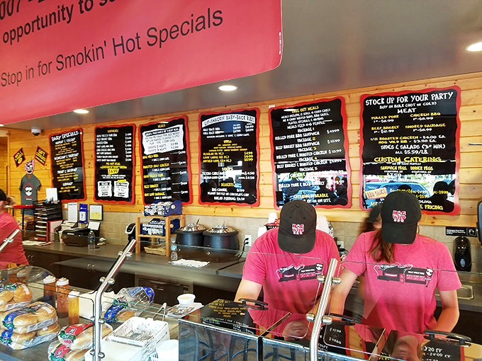 The front line heroes of Hog Wild, dressed in matching pink shirts, stand ready to fulfill your barbecue fantasies with practiced efficiency and genuine Michigan warmth.