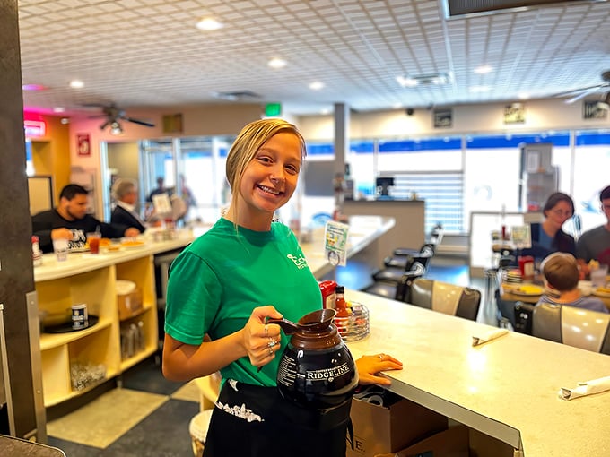 The green-shirted staff moves with the practiced efficiency of breakfast ballerinas, coffee pots in hand, ready to perform the sacred ritual of the refill.