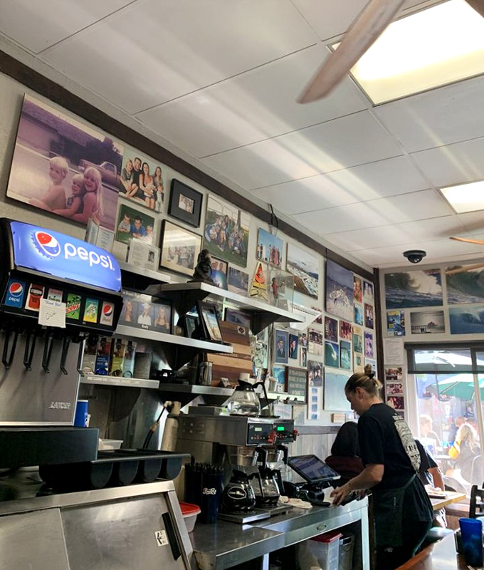 Behind the counter, where breakfast dreams come true. The staff moves with the practiced efficiency of people who truly know their craft.