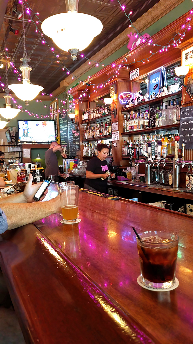 Behind every great drink is a focused professional. This bartender's concentration suggests something spectacular is in the works.