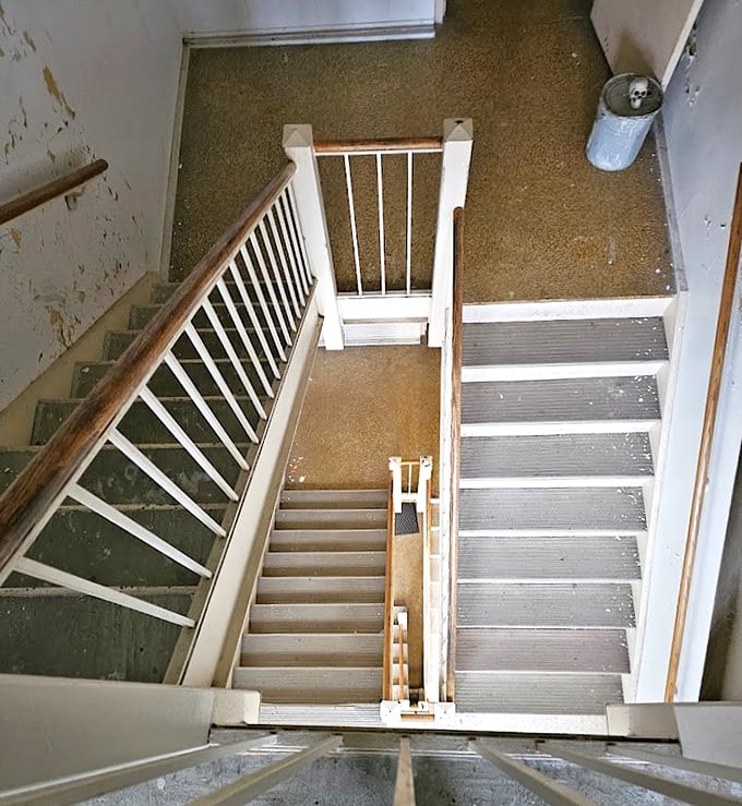 Staircases like these have witnessed countless journeys&mdash;both up and down&mdash;some voluntary, others decidedly not. The institutional white paint can't hide their stories.