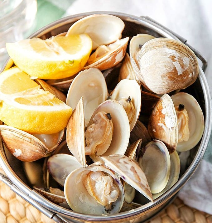 A bucket of fresh steamed clams with bright lemon wedges is the perfect way to start a Maryland seafood feast.