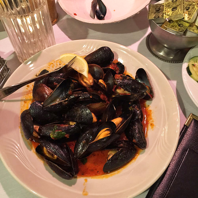 Steamed mussels swimming in aromatic red sauce that begs for crusty bread to soak up every drop.