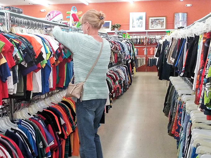 The seasoned thrifter knows exactly where to look. Watch and learn as the regulars navigate these colorful clothing canyons with practiced precision.