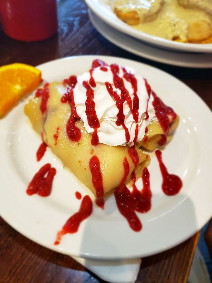 This crepe is wearing whipped cream like a jaunty hat and raspberry sauce like a designer scarf. Breakfast fashion at its finest.