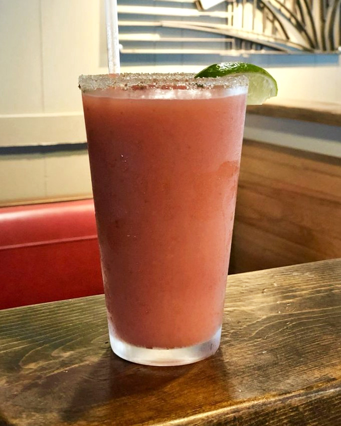 This isn't just a strawberry margarita—it's summer in a glass, rimmed with promise and garnished with weekend possibilities.