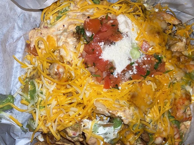 This mountain of surf and turf nachos proves that sometimes more is more, especially when shrimp and chicken join forces.