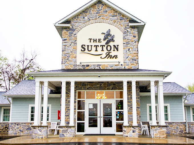 The Sutton Inn's stone façade and welcoming porch invite travelers to stay awhile. Like a warm hug from a building.
