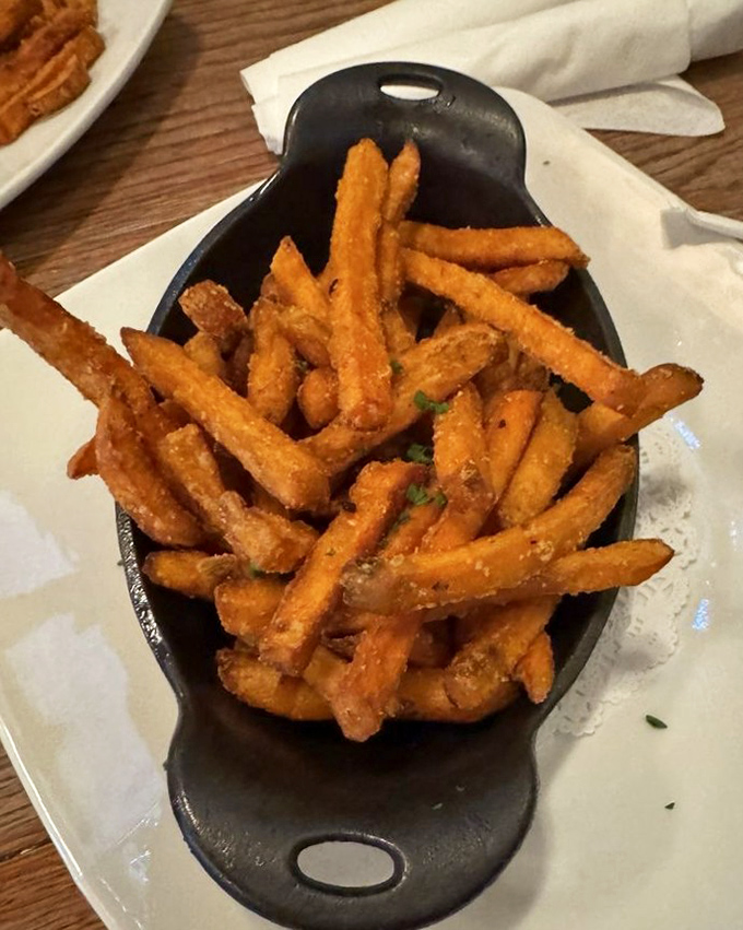 Sweet potato fries served in a cast iron skillet&mdash;because regular fries just don't have the same dramatic entrance or addictive quality.