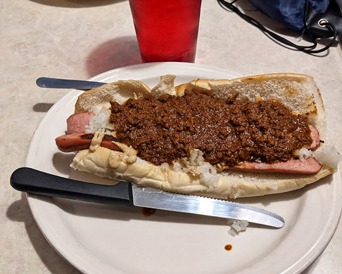 The star attraction in all its glory &ndash; a Texas Weiner with that signature chili sauce cascading down the sides. Poetry in hot dog form.