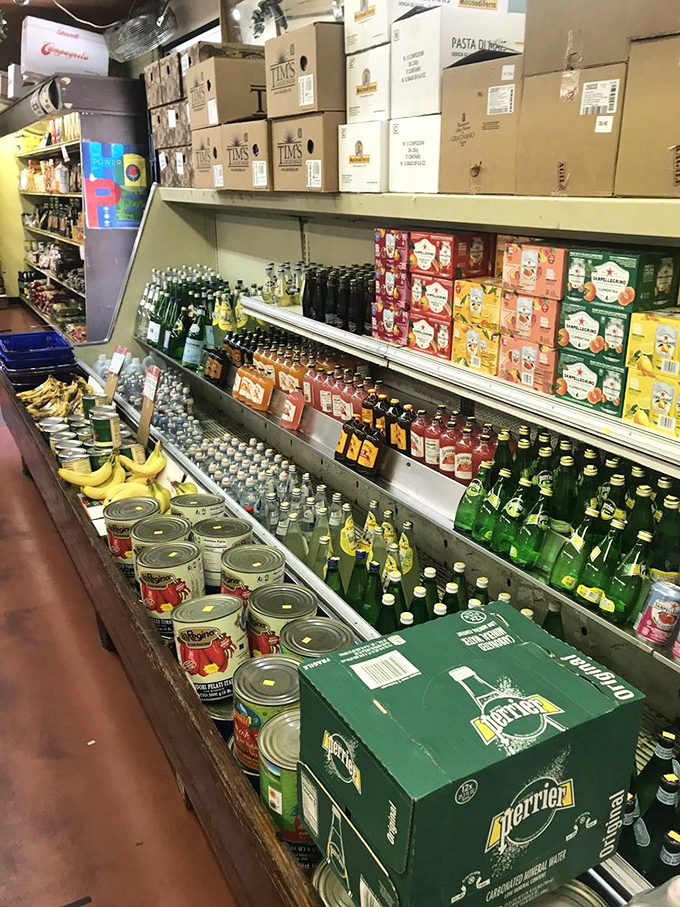 The beverage aisle – where Italian sodas and mineral waters stand at attention, ready for your next meal's supporting role.