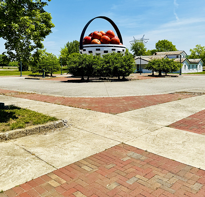 Pathways converge toward basket greatness. The brick walkways create perfect leading lines, drawing visitors inexorably toward this temple of fruit containment.