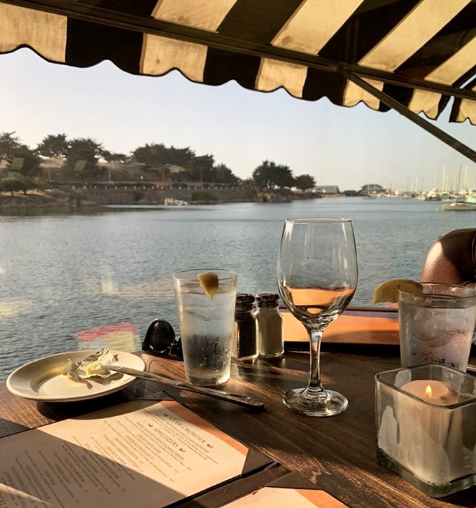 The view from the patio frames Monterey Bay like a living postcard&mdash;where your wine glass, menu, and the gentle harbor waters create the perfect California trifecta.