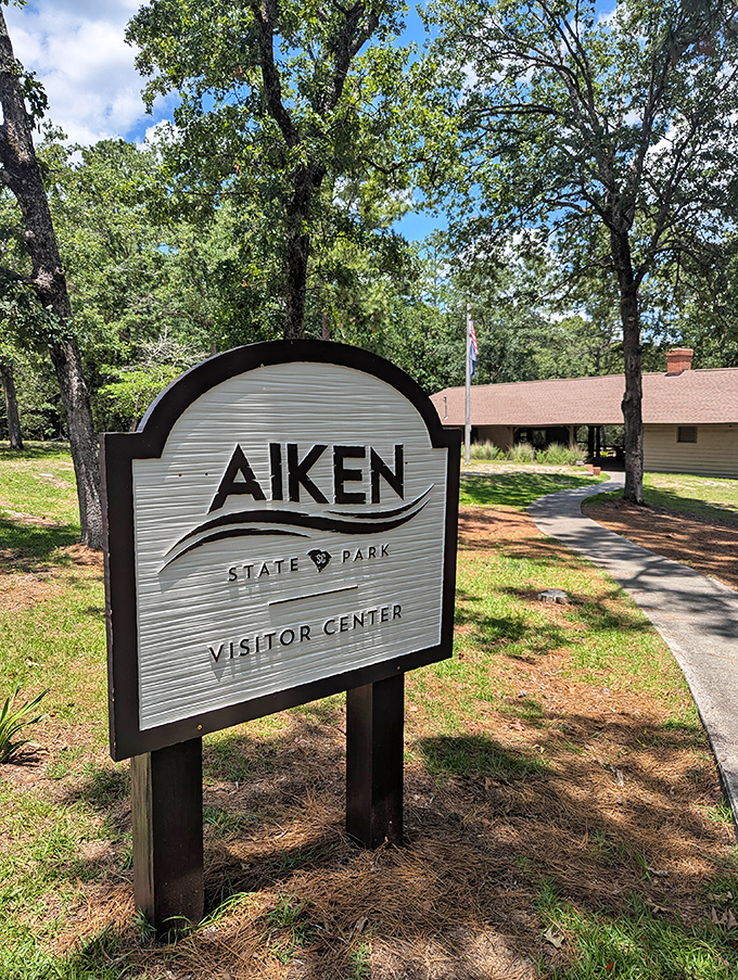 The Visitor Center sign doesn't just point the way&mdash;it's your first hello from a place that specializes in making you feel welcome in the wild.