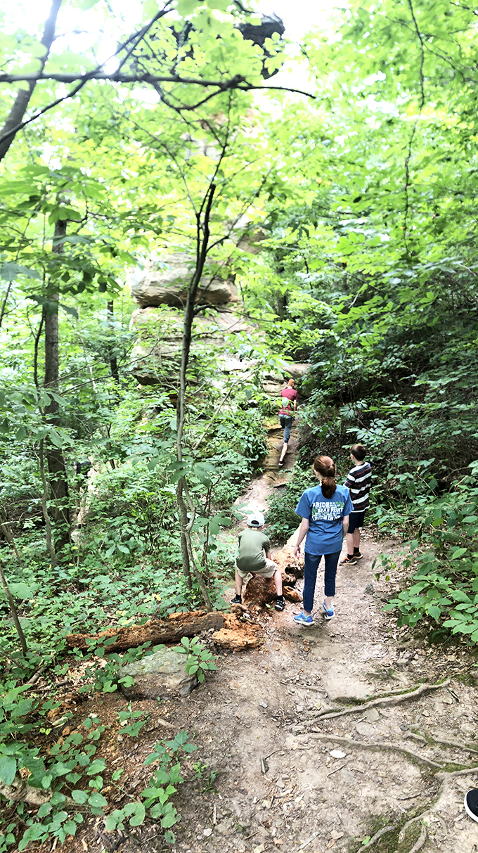 Fellow explorers scale the trail, providing scale to the massive formations. That feeling when you realize you're just a tiny blip in geological time.