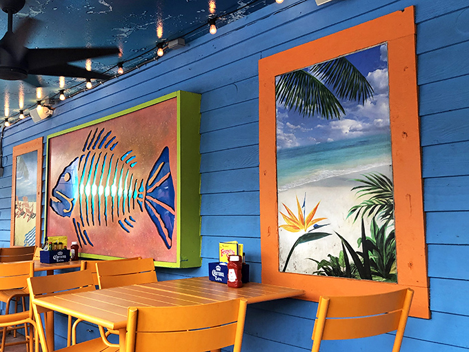 Tropical wall art that says "beach vacation" without the sunburn &ndash; blue walls bringing ocean vibes indoors year-round.