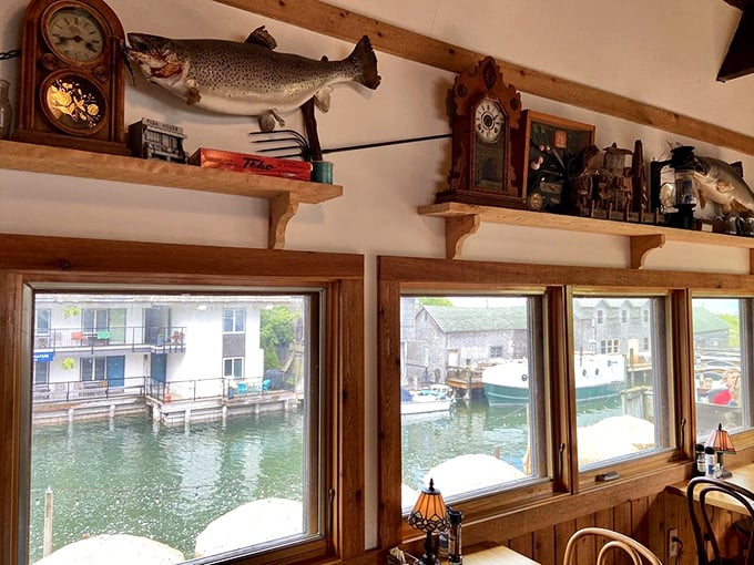 Taxidermied fish keep watch over diners from wooden shelves, silently judging your seafood selection while vintage clocks mark time spent in culinary bliss.