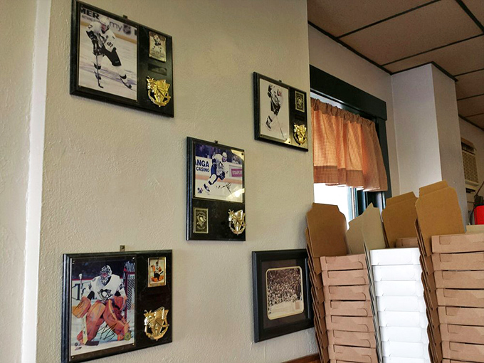 The walls tell stories of Pittsburgh sports legends while stacked pizza boxes stand ready for the next rush &ndash; a temple of both local pride and pizza passion.