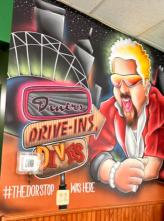 A mural paying homage to the restaurant's Food Network fame. Guy Fieri's likeness watches over diners like a spiky-haired guardian angel.