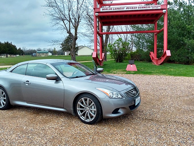 Sleek modern vehicles meet retro roadside charm. This sports car looks like it's auditioning for a supporting role in the Red Rocker's ongoing show.