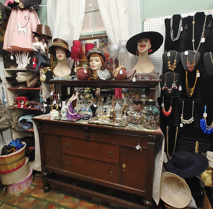The mannequin heads seem to be plotting something fabulous, surrounded by vintage jewelry and accessories from fashion eras gone by.