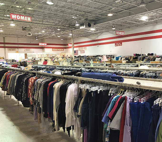 The women's section stretches toward the horizon like a fashion desert mirage. Red signs guide shoppers through this wilderness of potential wardrobe revolutions.