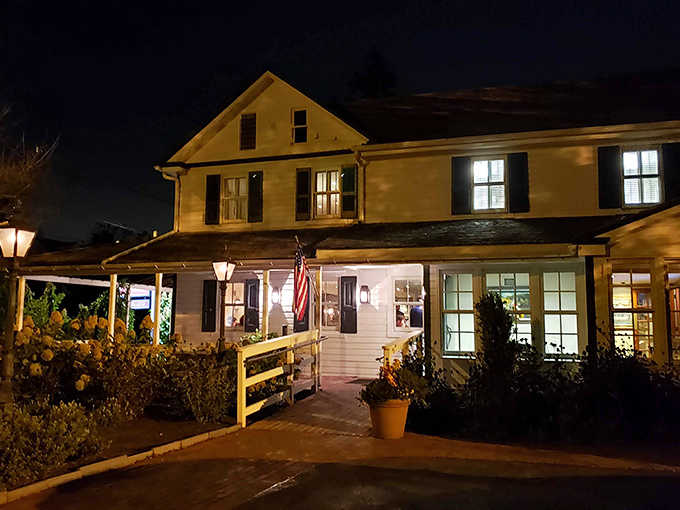 As night falls, Buckley's Tavern glows like a lighthouse for hungry travelers and locals seeking culinary refuge.