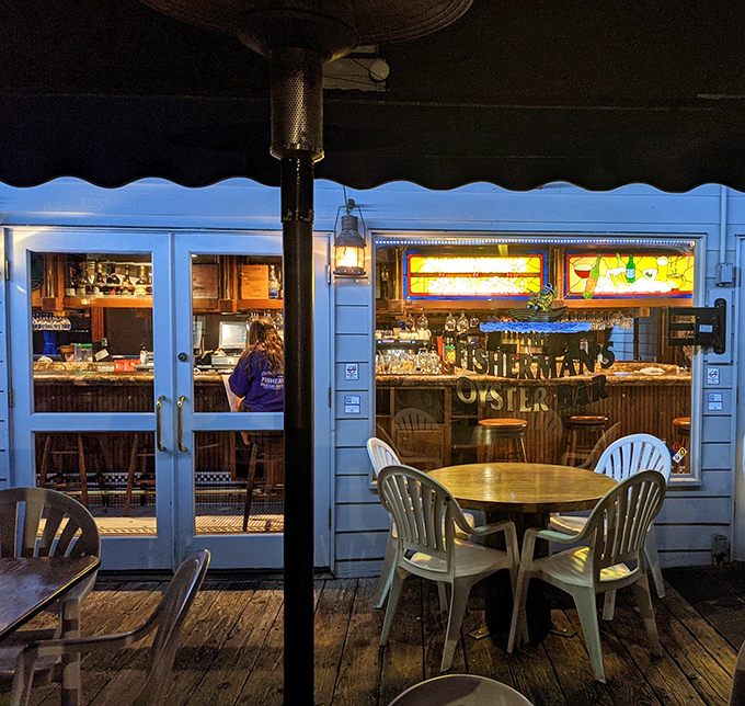 As evening falls, Fisherman's transforms into a glowing beacon of hospitality, where ocean breezes carry the promise of oysters and good times.