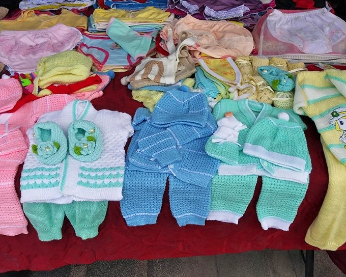 Handmade baby ensembles in pastel perfection. Grandparents beware: resistance to purchasing these adorable outfits is futile.