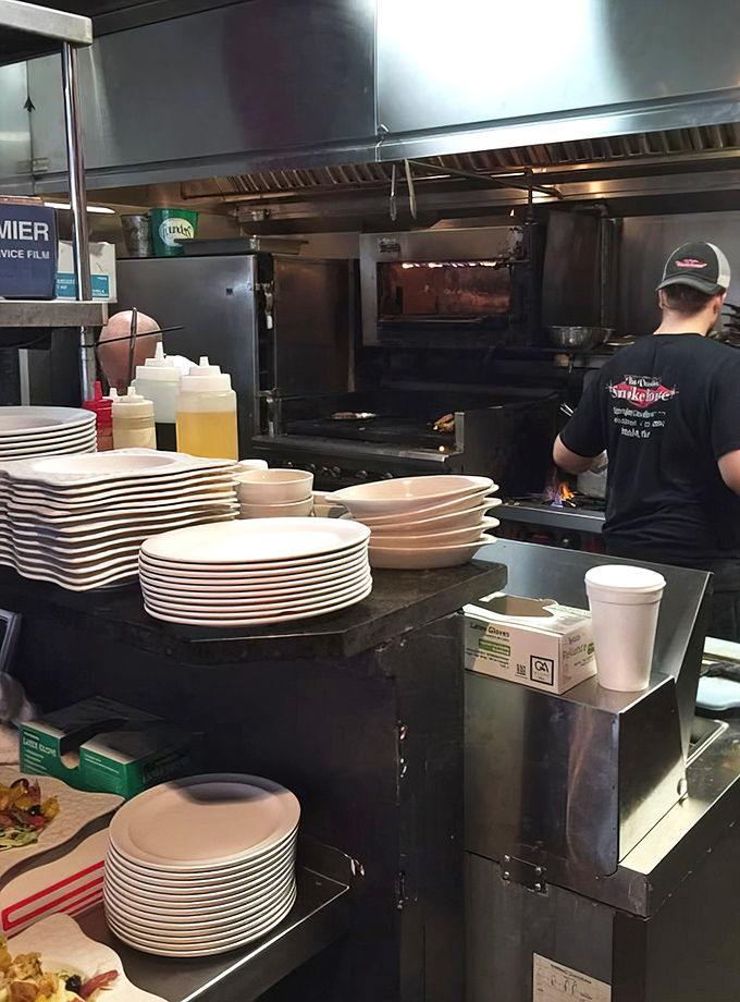 Where the magic happens: The kitchen pass reveals stacks of plates waiting to be filled with smoky treasures. BBQ is serious business here.