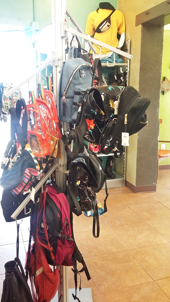 Backpacks and bags hang like colorful fruit, ready to be plucked by shoppers who appreciate both sustainability and style without the luxury price tag.