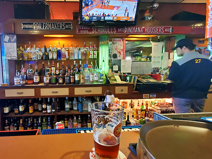 The bar showcases Indiana's sports loyalties with Boilermakers, Hoosiers, and Seminoles signs watching over patrons. Where rivals can unite over excellent chicken and cold drinks.
