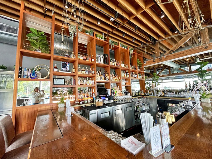 Not just a bar, but a liquid library of possibilities, where bottles stand at attention and plants add a touch of tropical flair.