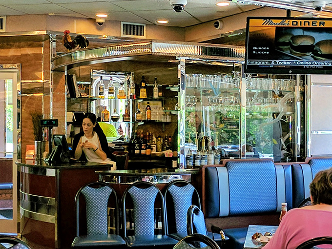 The bar area—where coffee is currency and the staff conducts the daily ritual of turning strangers into regulars with practiced ease.