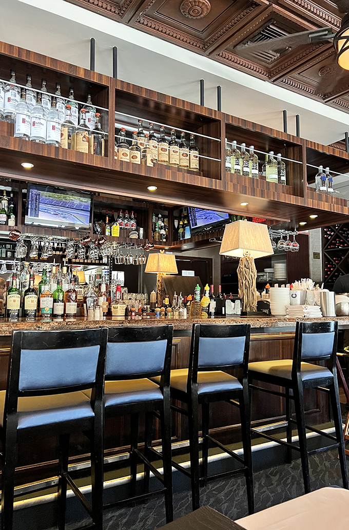 The bar gleams with amber bottles and warm lighting, promising libations that complement the ocean's bounty waiting at your table.