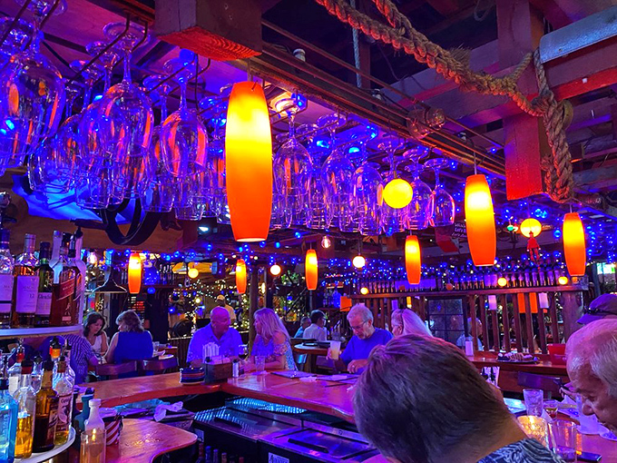 The bar area invites lingering conversations over perfectly crafted cocktails and shared laughter with friends.