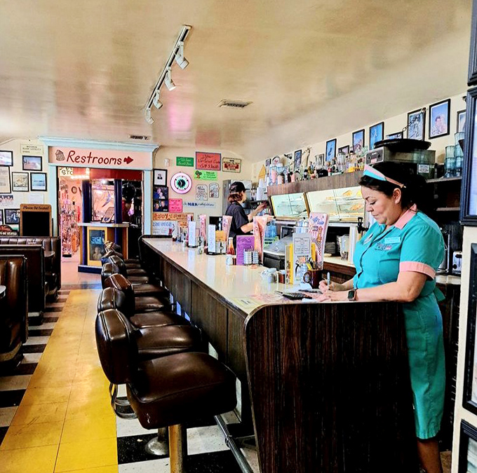 The counter seating offers front-row tickets to the short-order show, where staff in period uniforms keep the diner's heartbeat thumping.