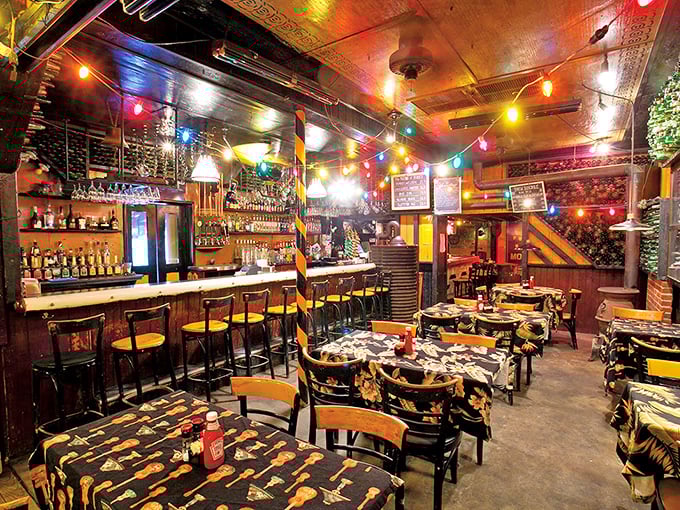 The bar area buzzes with energy while maintaining that cozy tavern charm of yesteryear.