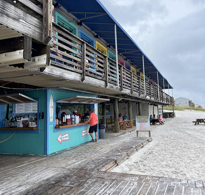 Beach-level access means you're practically dining with your toes in the sand. The weathered boardwalk has supported countless happy, sandy feet heading toward seafood paradise. 